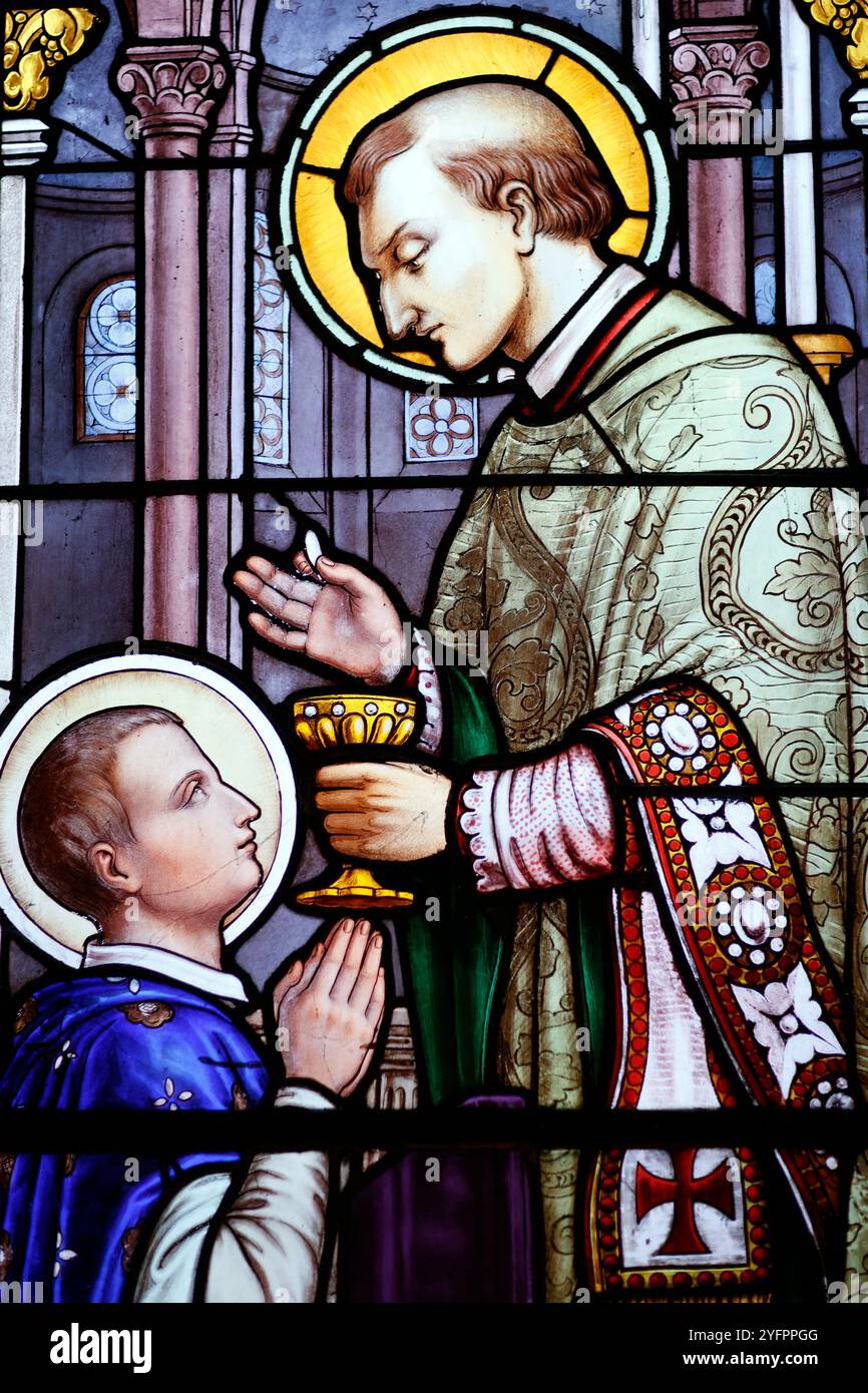 Sainte Blandine church. Priest giving holy Communion. Stained glass ...