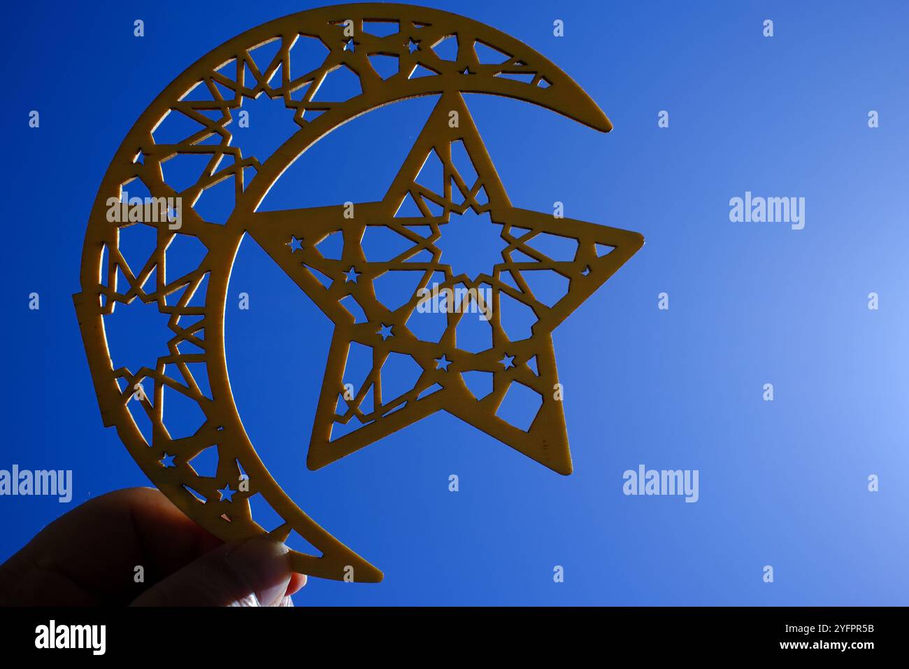 Islamic crescent moon and star agaisnt blue sky. Symbol of Islam ...