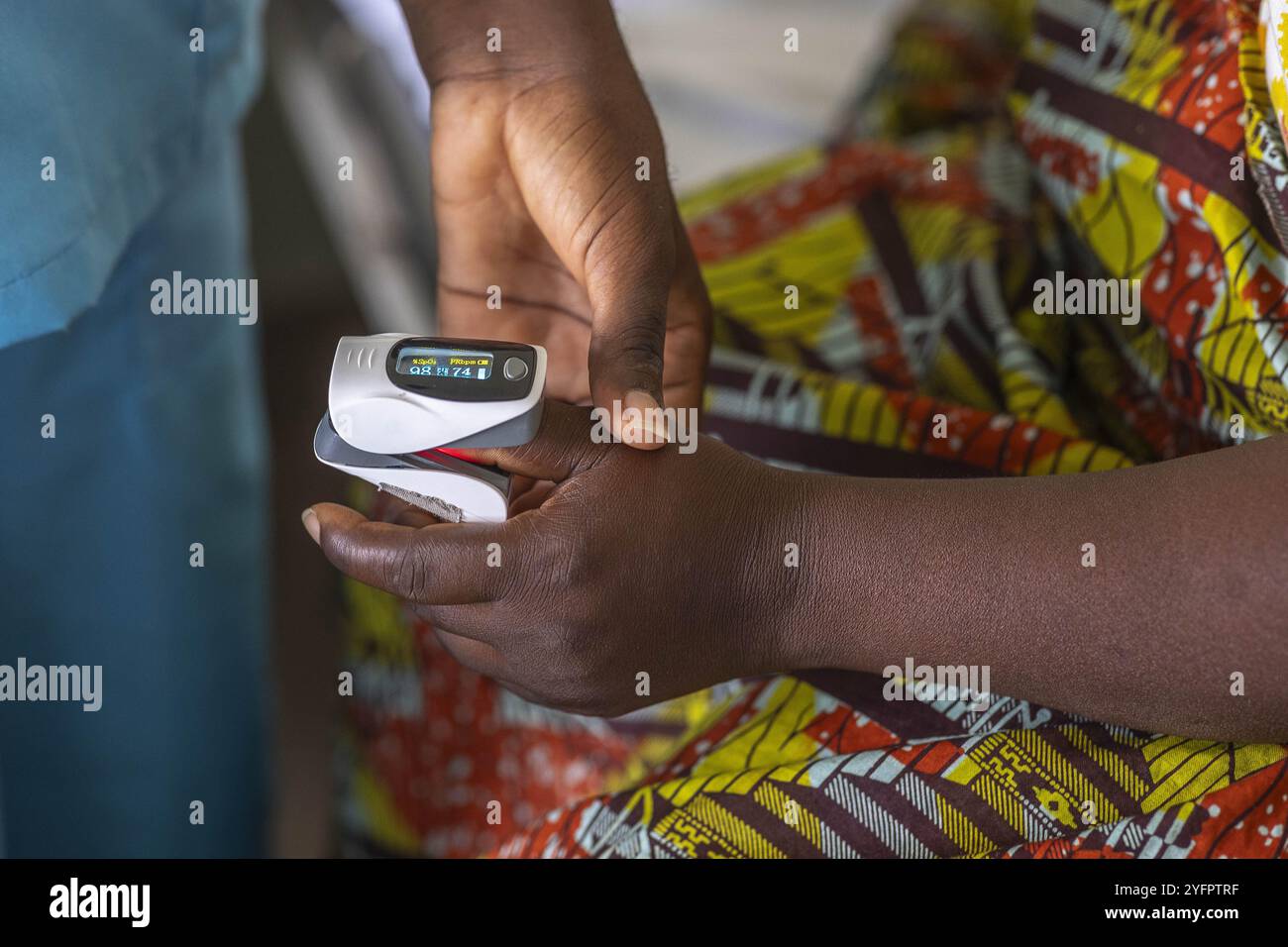 Nurse measuring a patientÕs oxygen saturation level in a private ...