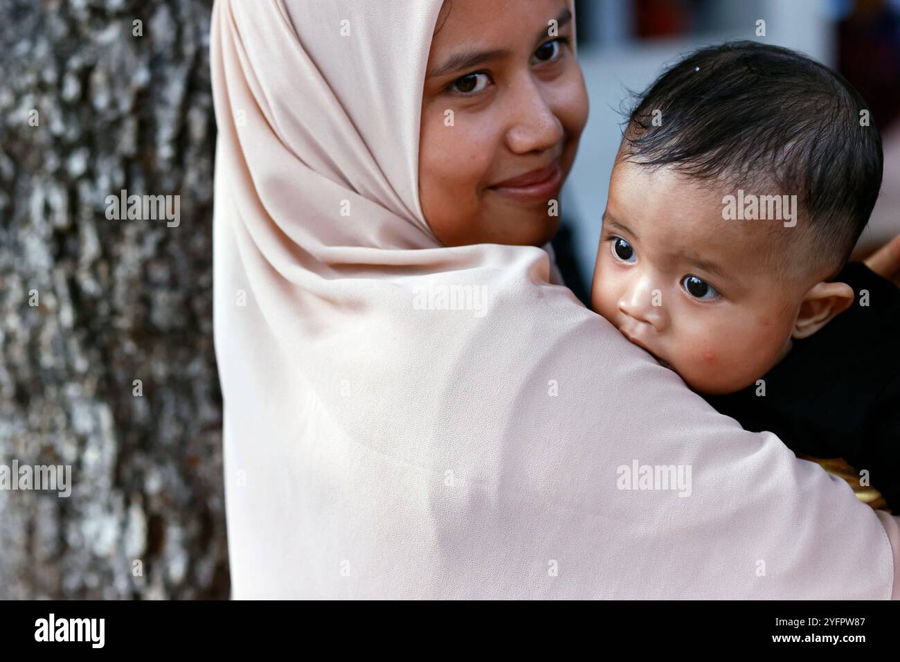 Indonesian woman wearing the traditional Islamic hijab veil. Indonesia ...