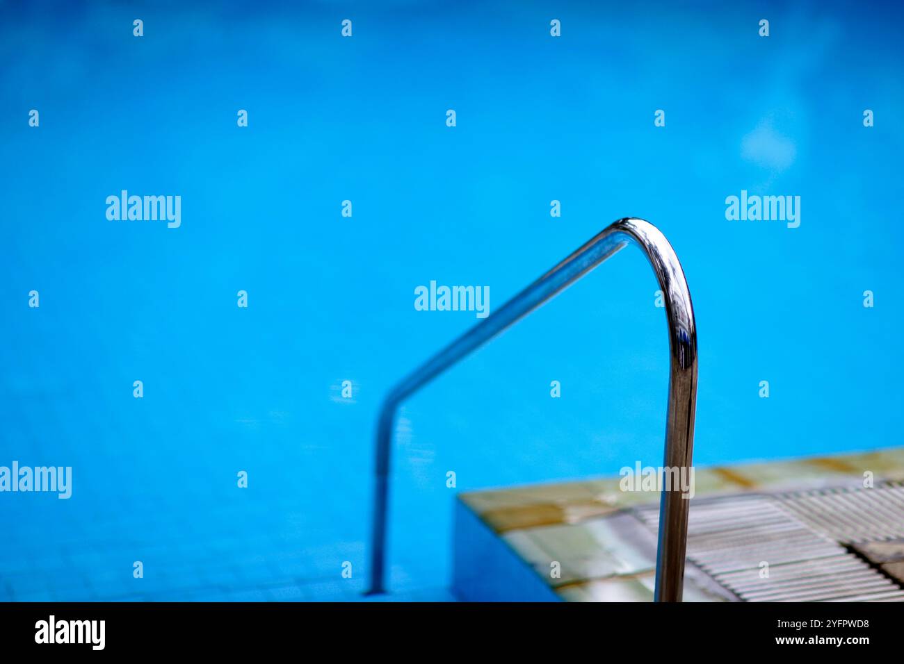Modern blue pool with stainless steel steps Stock Photo - Alamy