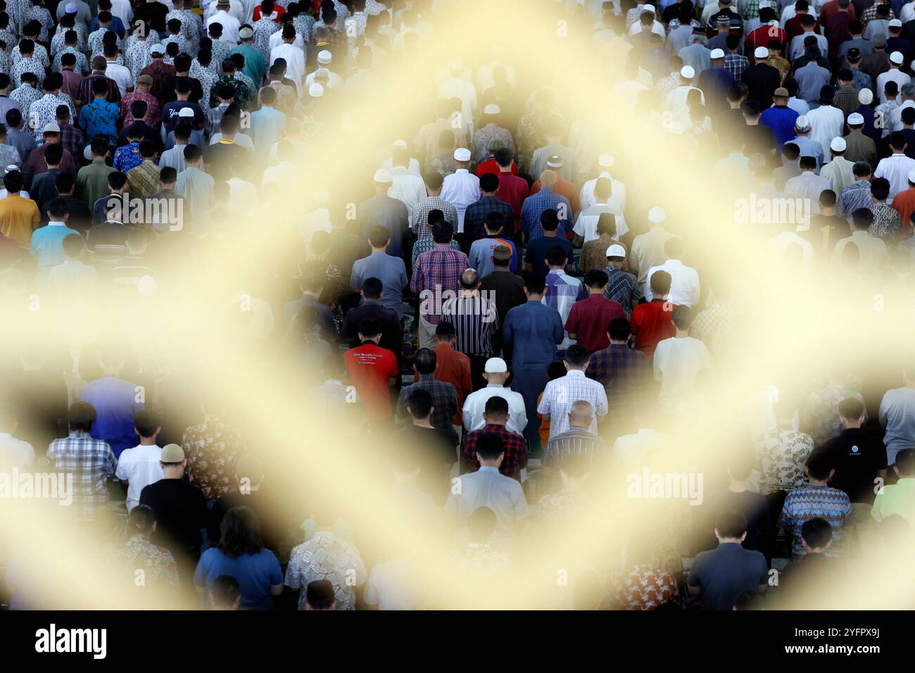 Al Akbar Surabaya National Mosque. Muslim men praying together at Friday prayer. Surabaya ...