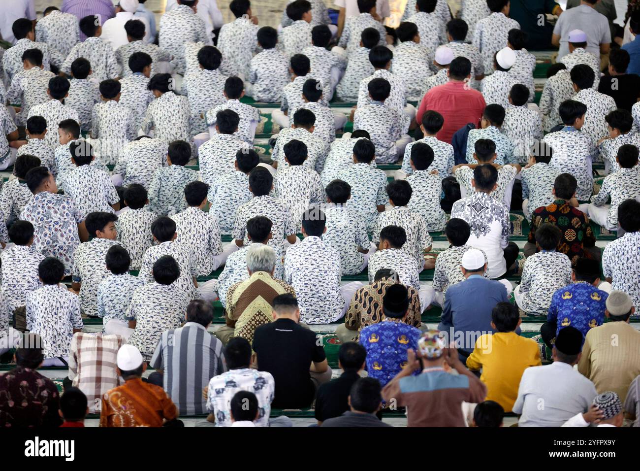 Al Akbar Surabaya National Mosque. Muslim men praying together at Friday prayer. Surabaya ...