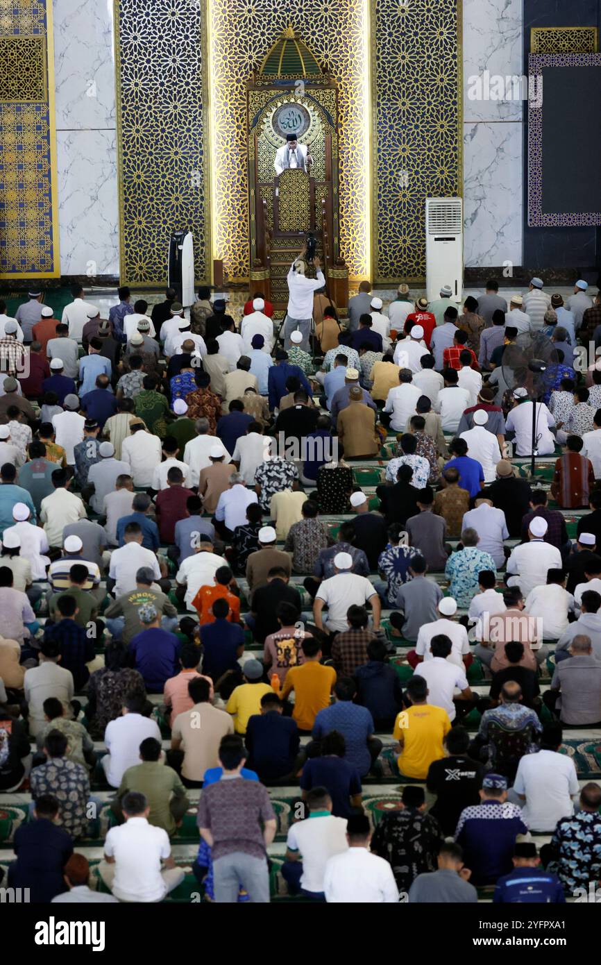 Al Akbar Surabaya National Mosque. Muslim men praying together at Friday prayer. Surabaya ...