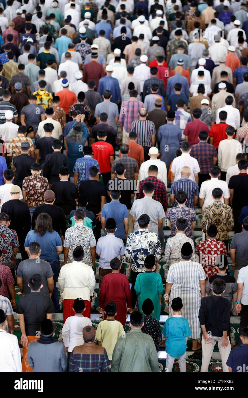Al Akbar Surabaya National Mosque. Muslim men praying together at Friday prayer. Surabaya ...
