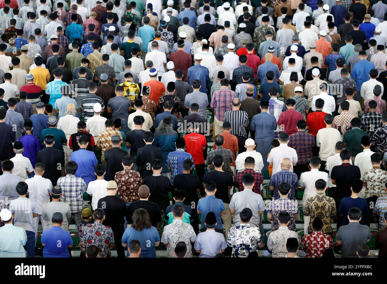 Al Akbar Surabaya National Mosque. Muslim men praying together at Friday prayer. Surabaya ...