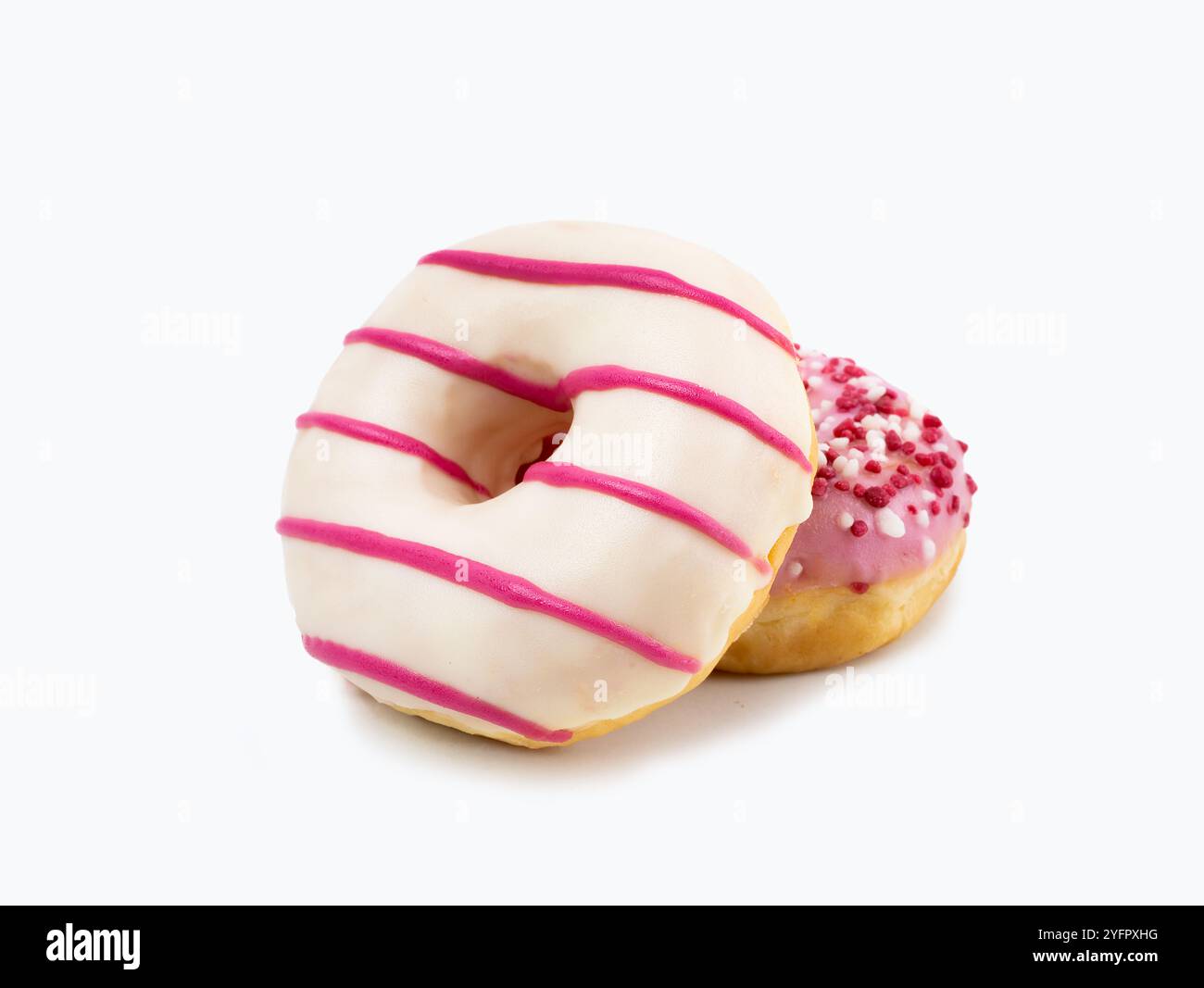 Two donut made of white chocolate and pink stripes with white ...
