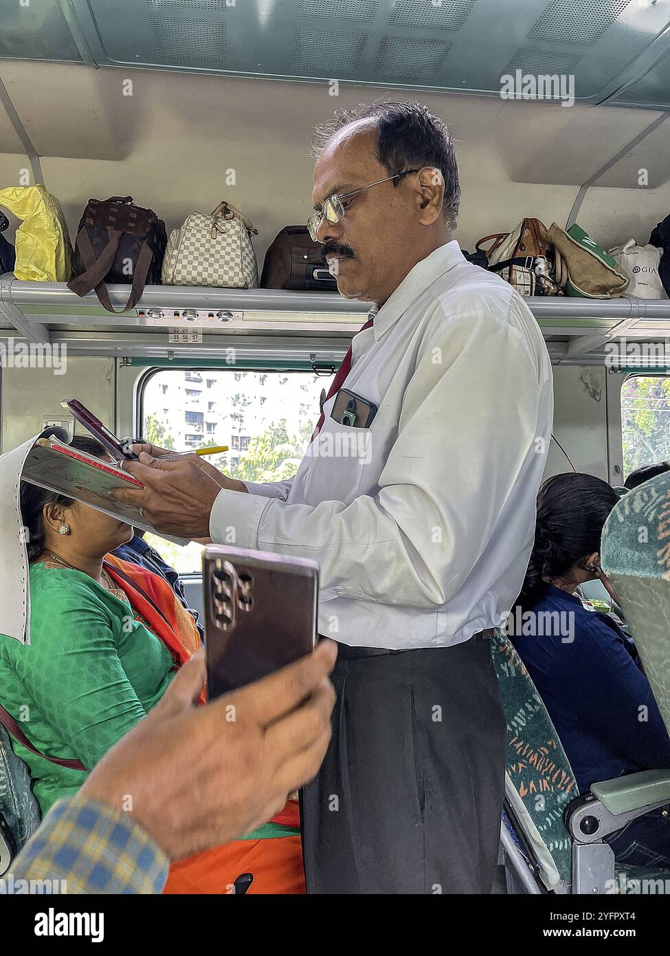 Ticket inspector on a train in Maharashtra, India Stock Photo - Alamy