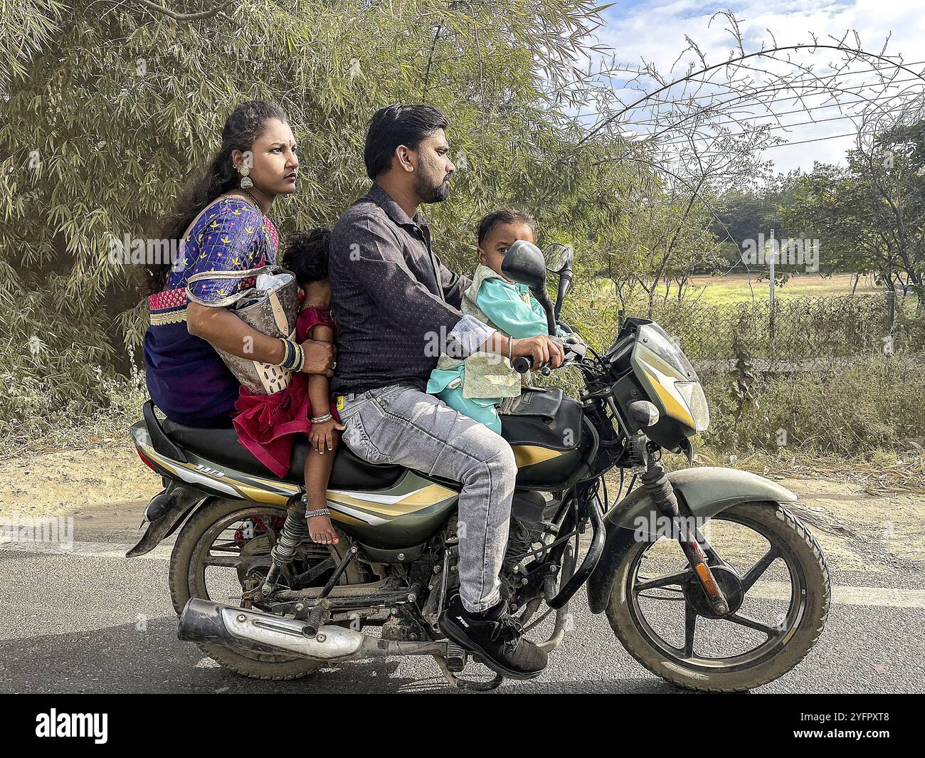 Family riding a motorcycle without helmets in Khuldabad, Maharashtra ...