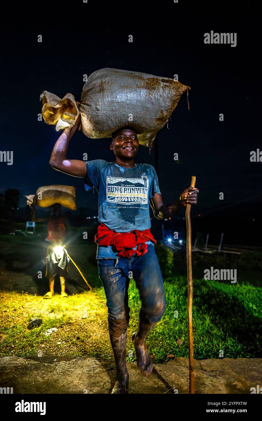 Children bringing coffee cherries to a coffee washing station, Rutsiro ...