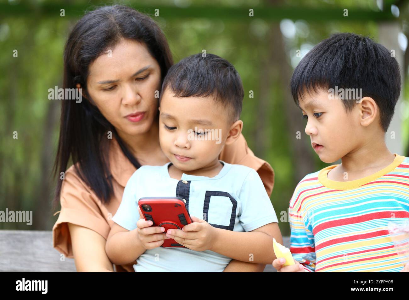 A warm moment captured of a mother and her children enjoying time ...
