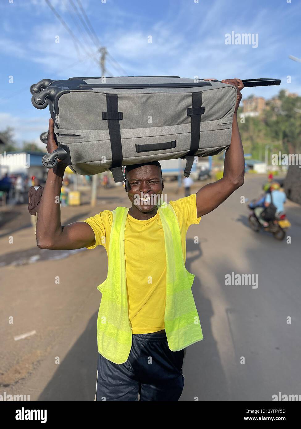 Porter carrying luggage at the Rwanda-DRC border, Cyangugu, Rwanda ...