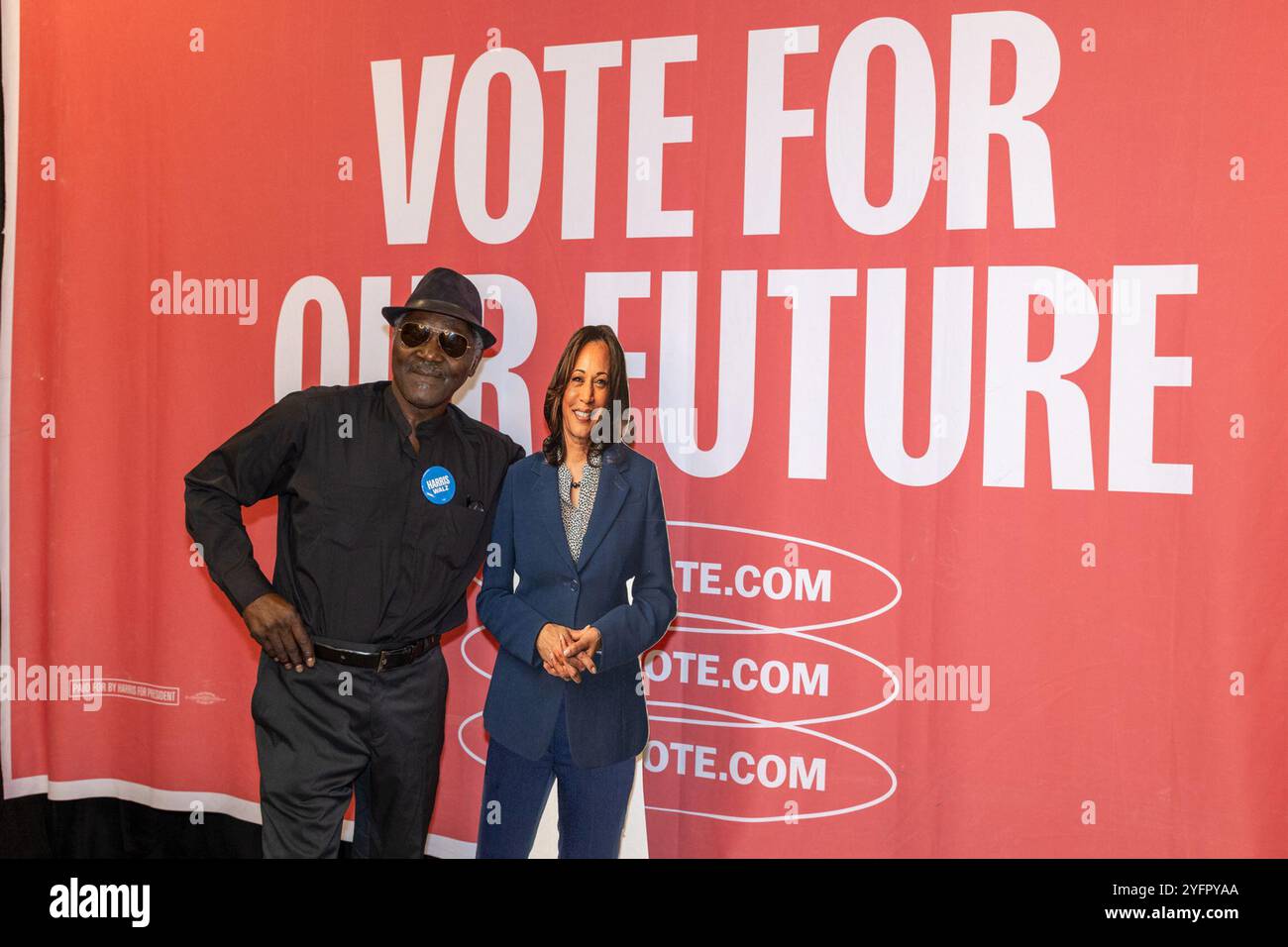 An audience member poses with a cardboard Kamala Harris at the When We ...