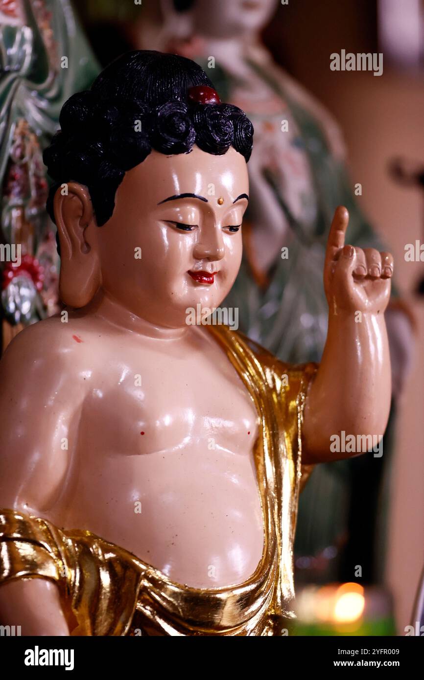 Cau dung Pagoda. Boy Buddha statue with long-ears, bald-headed and one ...