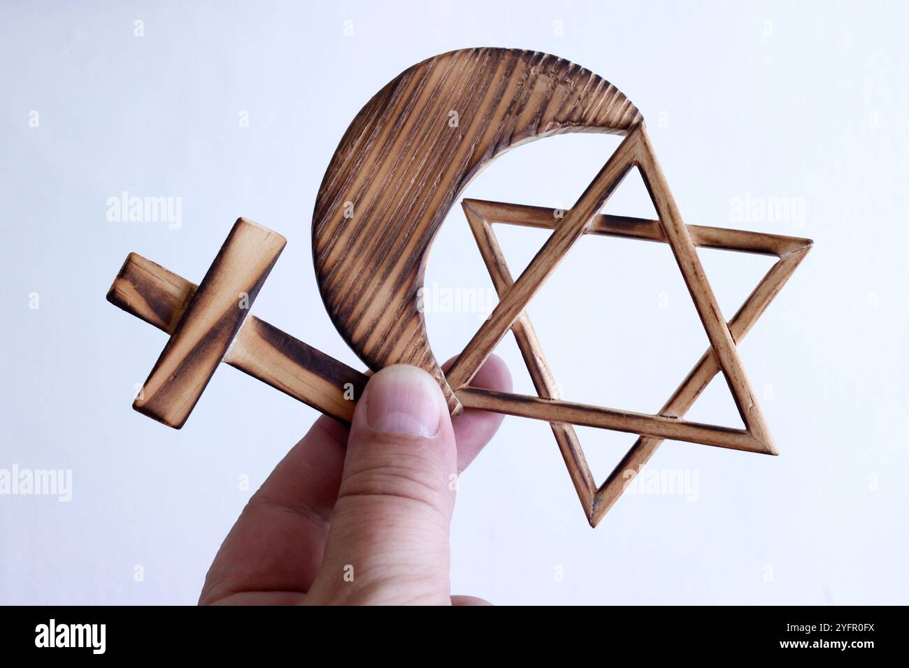 Religious symbols in hand. Jewish Star of David, Muslim star and ...