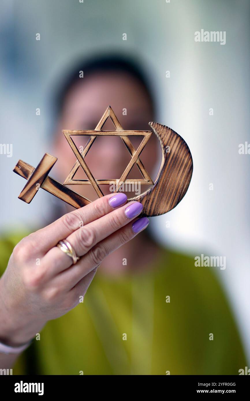 Religious symbols in hand. Jewish Star of David, Muslim star and ...