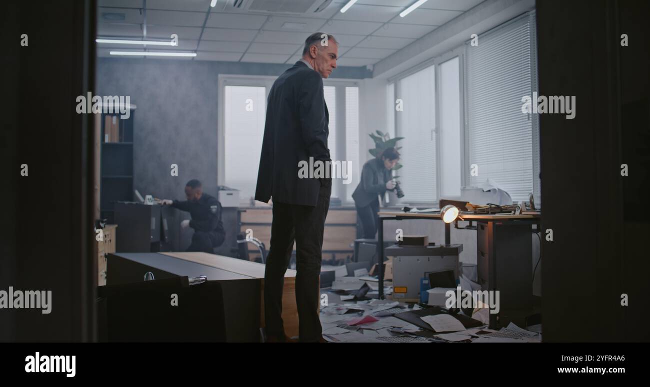 Office robbery case: Crime investigation team working. Male detective ...