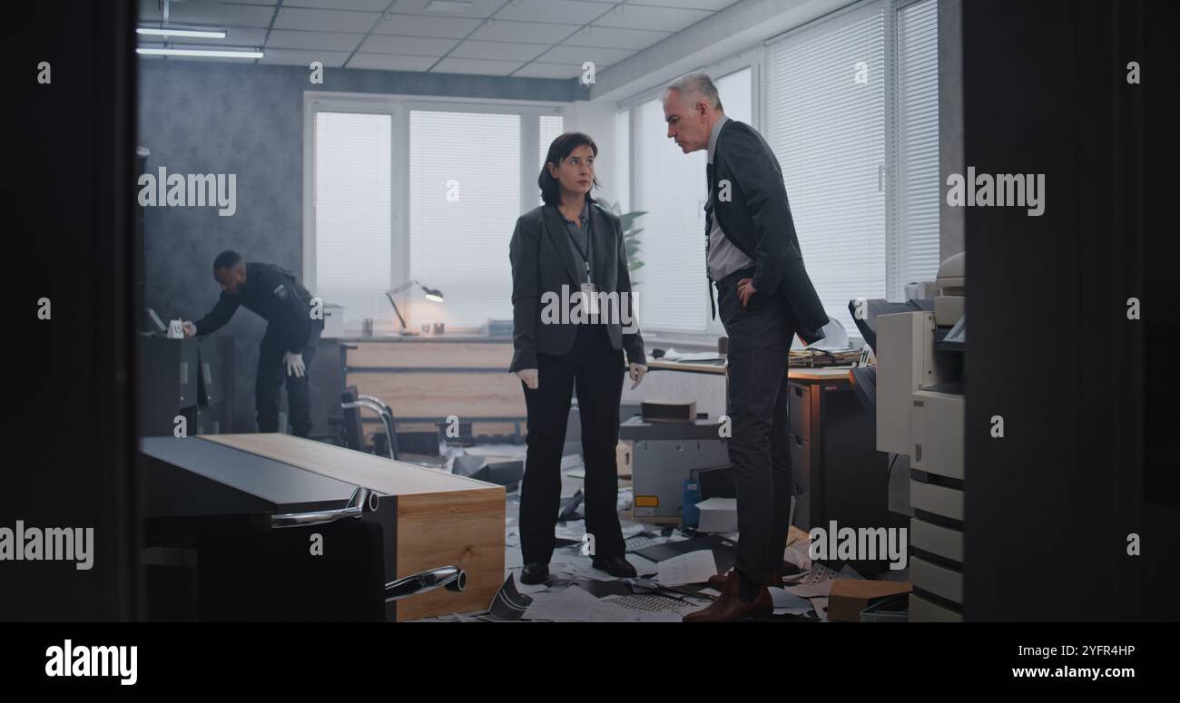 Office robbery case: Crime investigation team working. Male detective ...