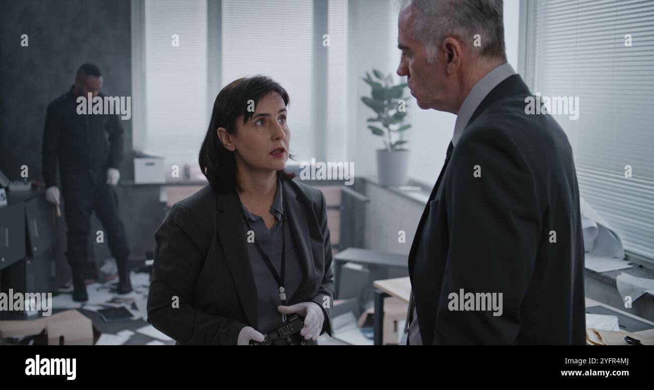 Office robbery case: Crime investigation team at crime scene. Female ...