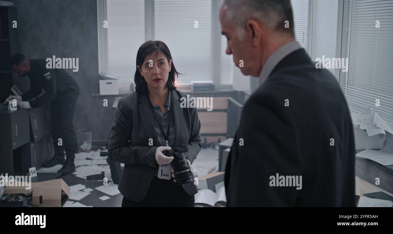 Office robbery case: Crime investigation team at crime scene. Female ...