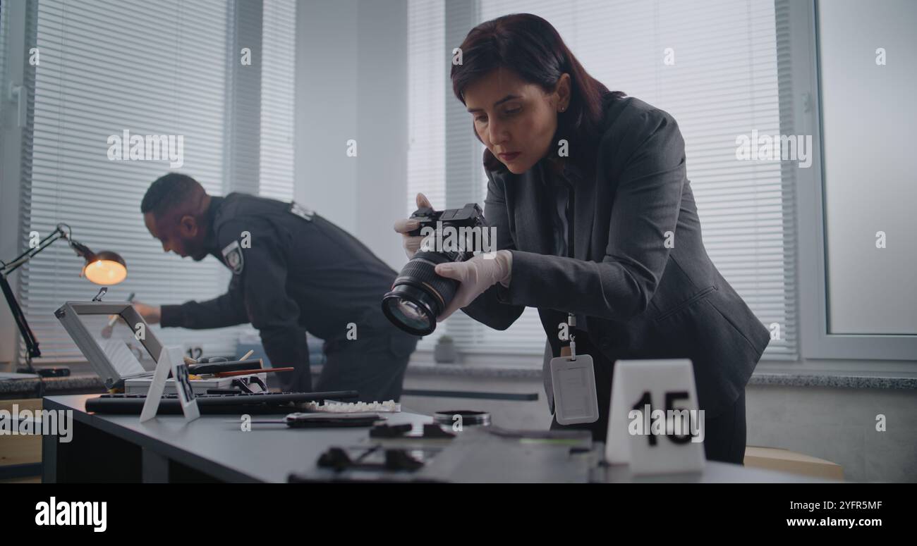 Investigation team working at crime scene: Female criminalist takes ...