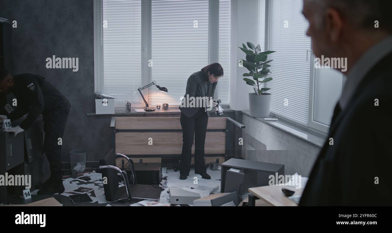 Office robbery case: Crime investigation team at crime scene. Female ...