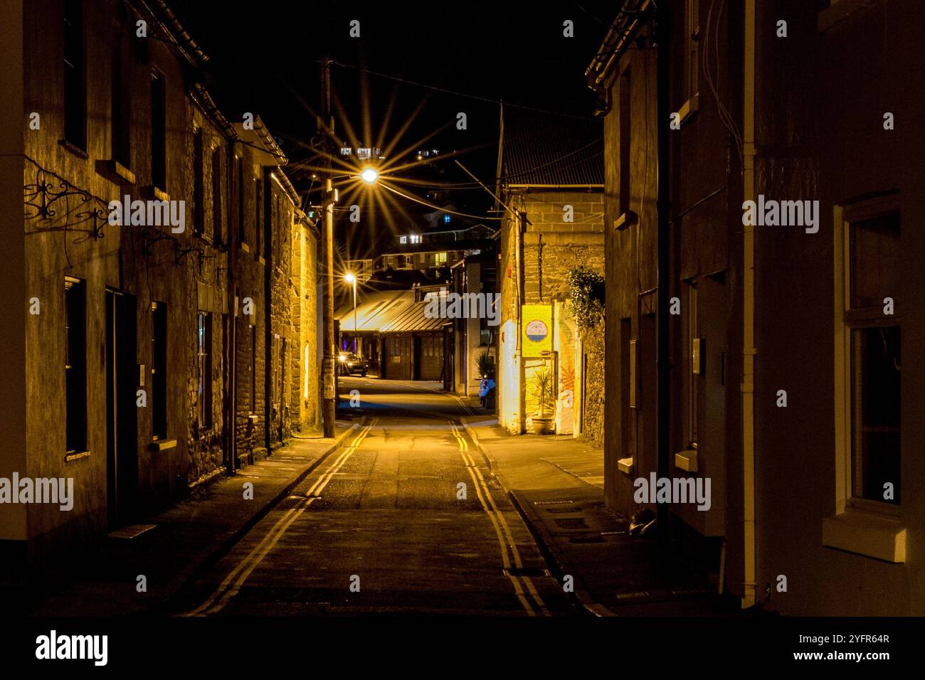 Night time view along a deserted Island Street, which is lit by a ...