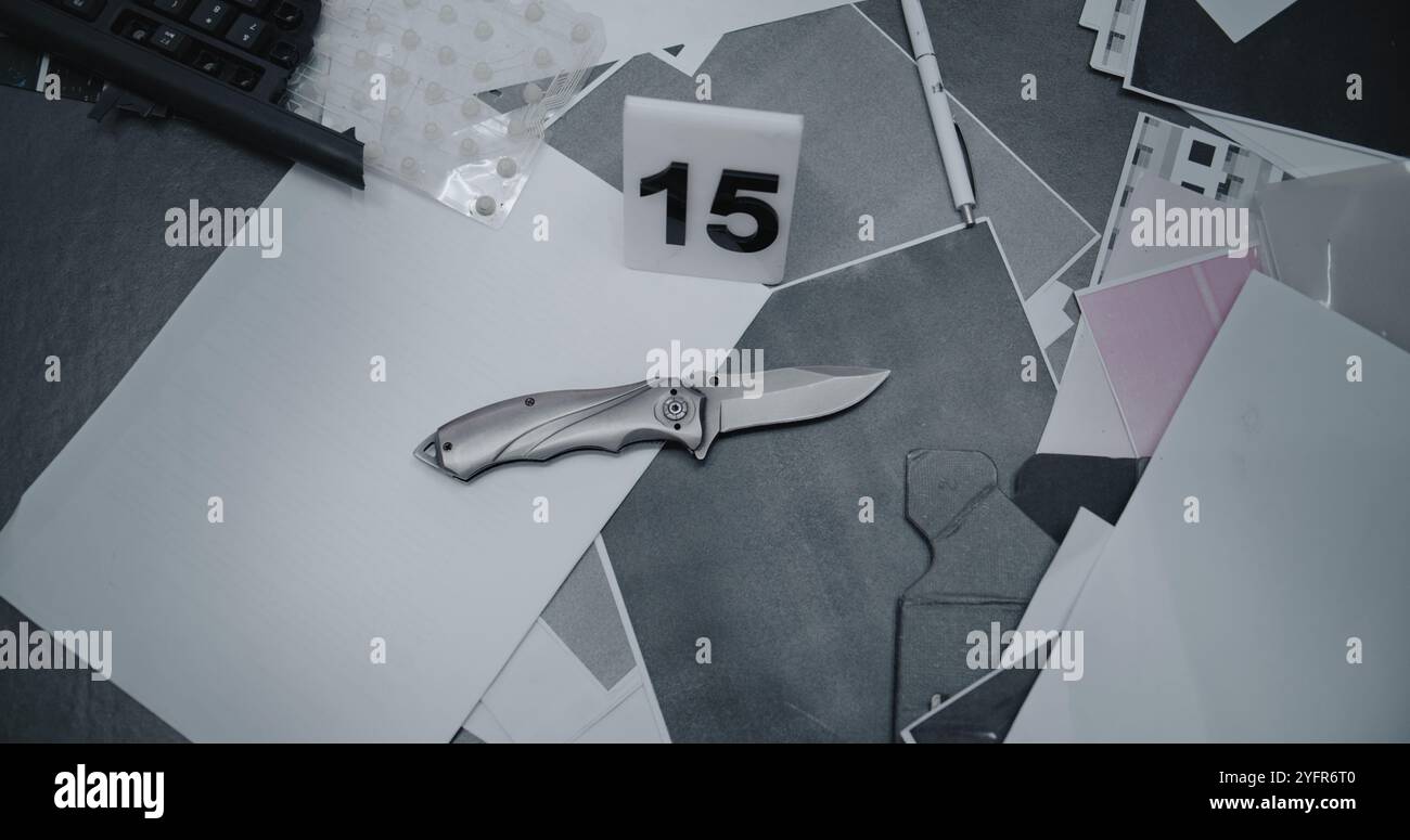 Bank robbery or murder case. Top view on murder weapon knife lying next ...