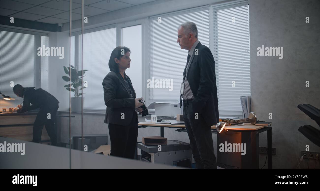 Office robbery case: Crime investigation team at crime scene. Female ...