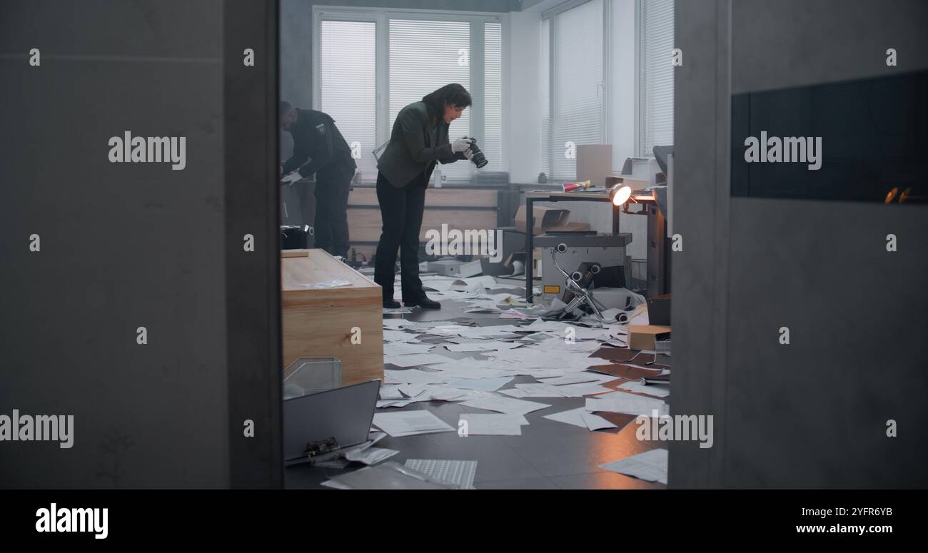 Investigation team working at crime scene: Female criminalist takes ...