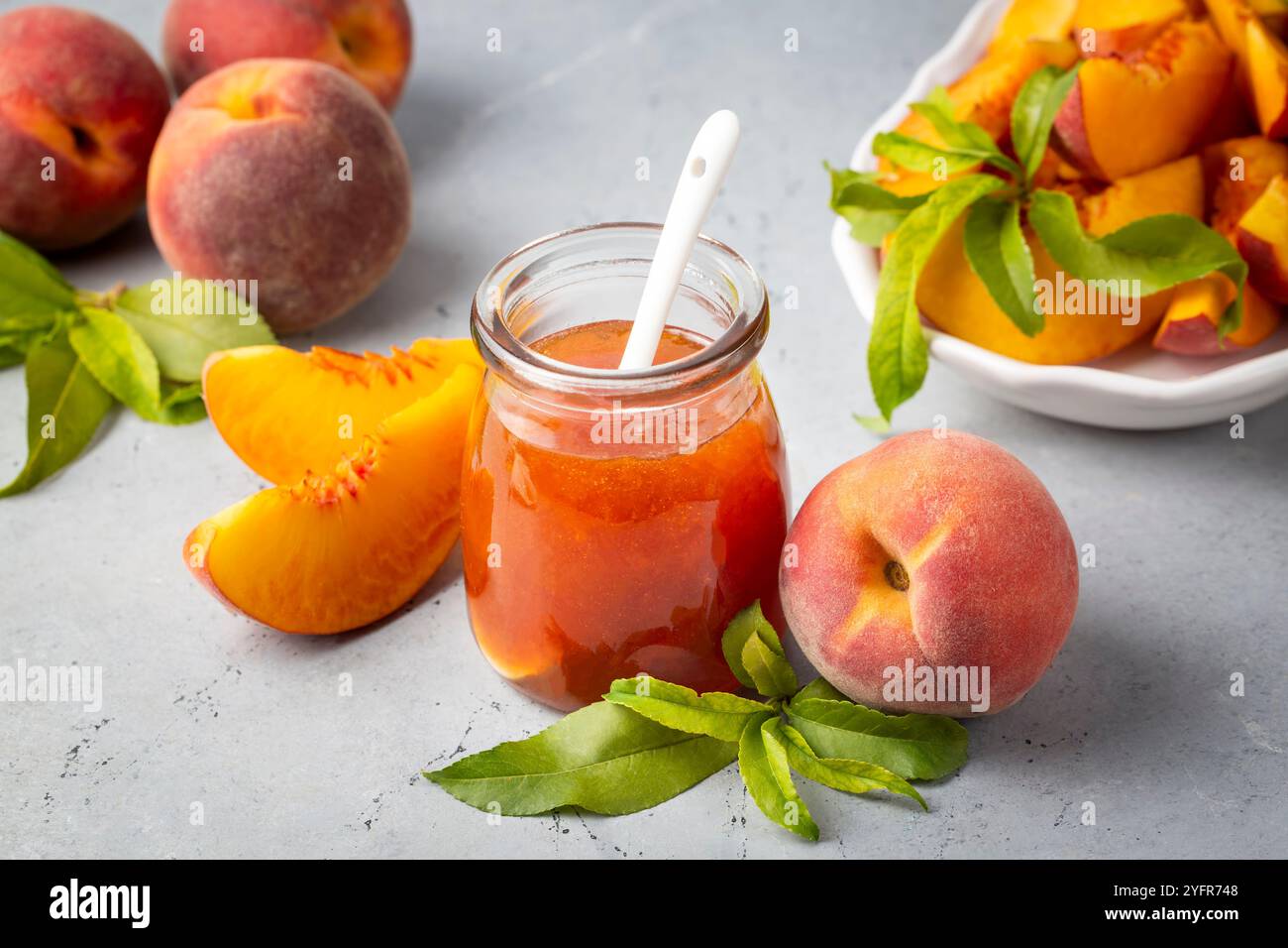Homemade peach jam in a jar with some fresh peaches Stock Photo - Alamy