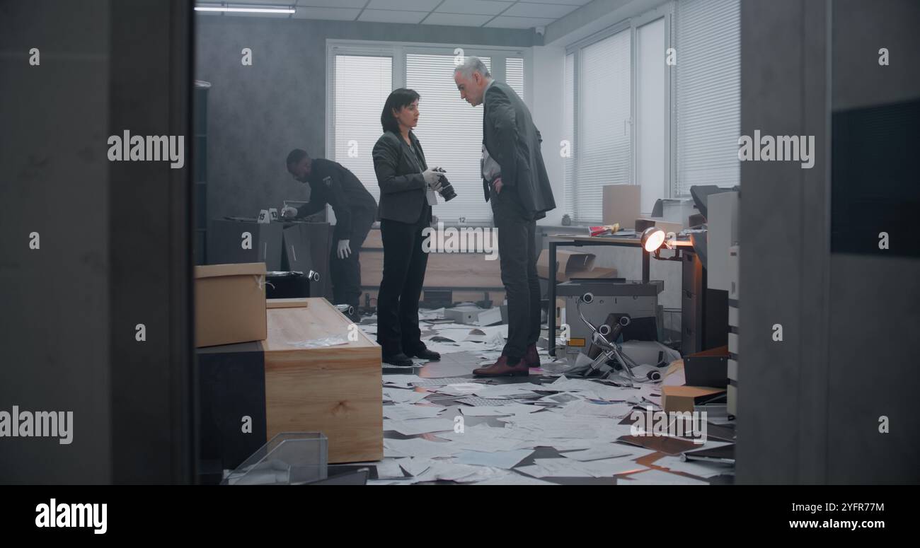 Investigation team working at crime scene: Female criminalist takes ...