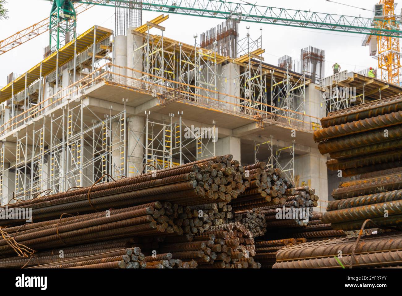 Steel rods stacked together at a construction site, with construction ...