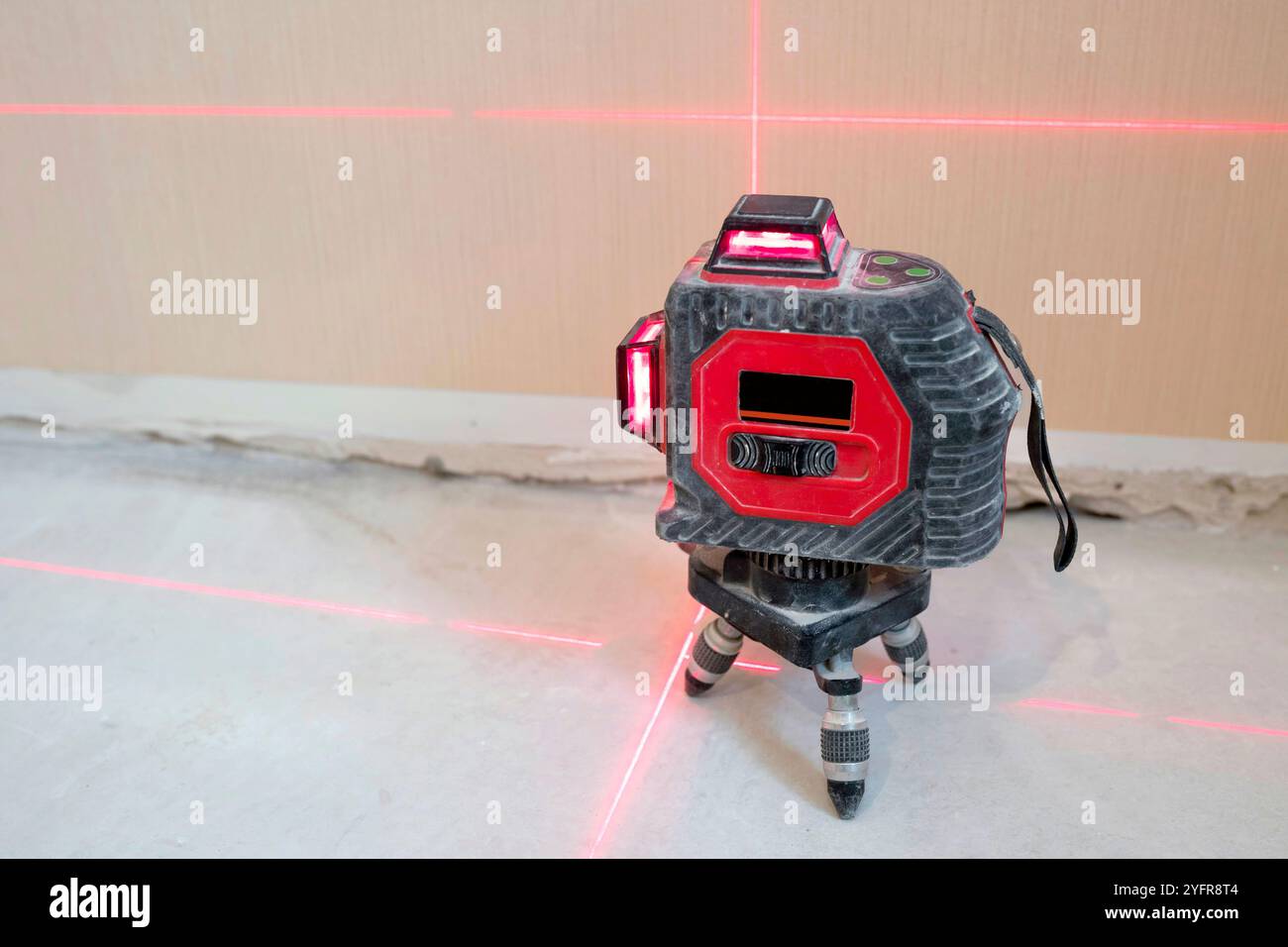 Construction laser level on a wall background. Apartment renovation ...