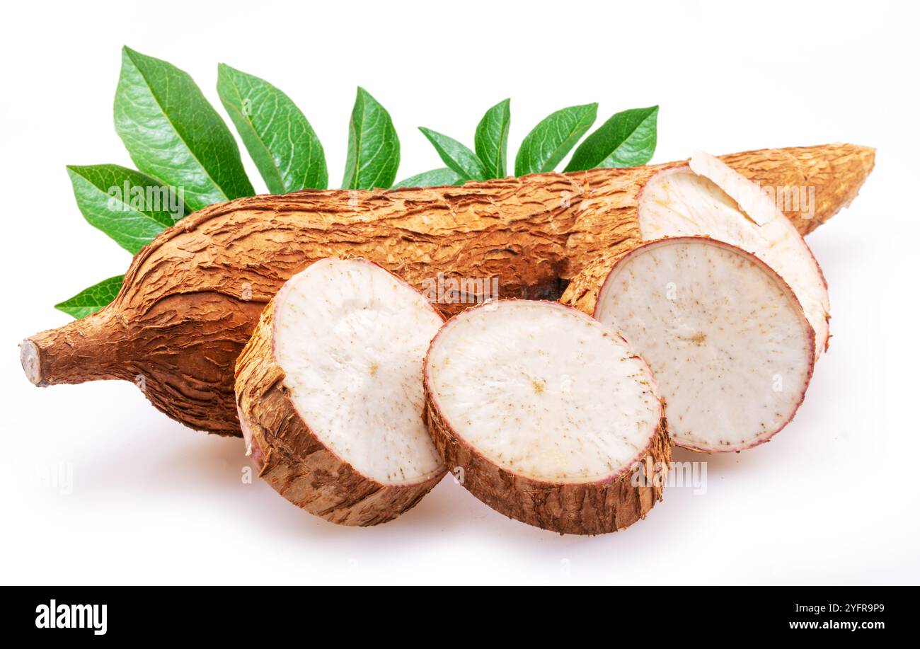 Cassava tubers with leaves and cassava slices isolated on white ...