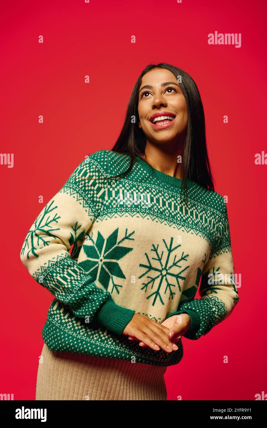 A cheerful young woman playfully poses in a cozy sweater adorned with ...