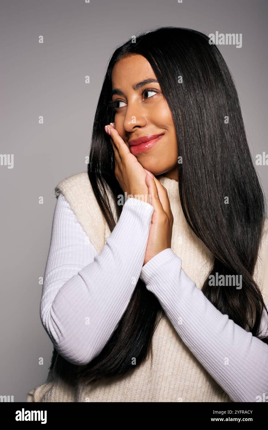 The woman radiates happiness with a charming smile while elegantly ...