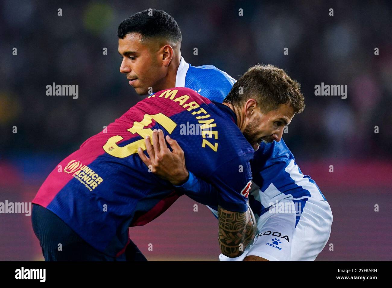 Inigo Martinez of FC Barcelona and Walid Cheddira of RCD Espanyol ...