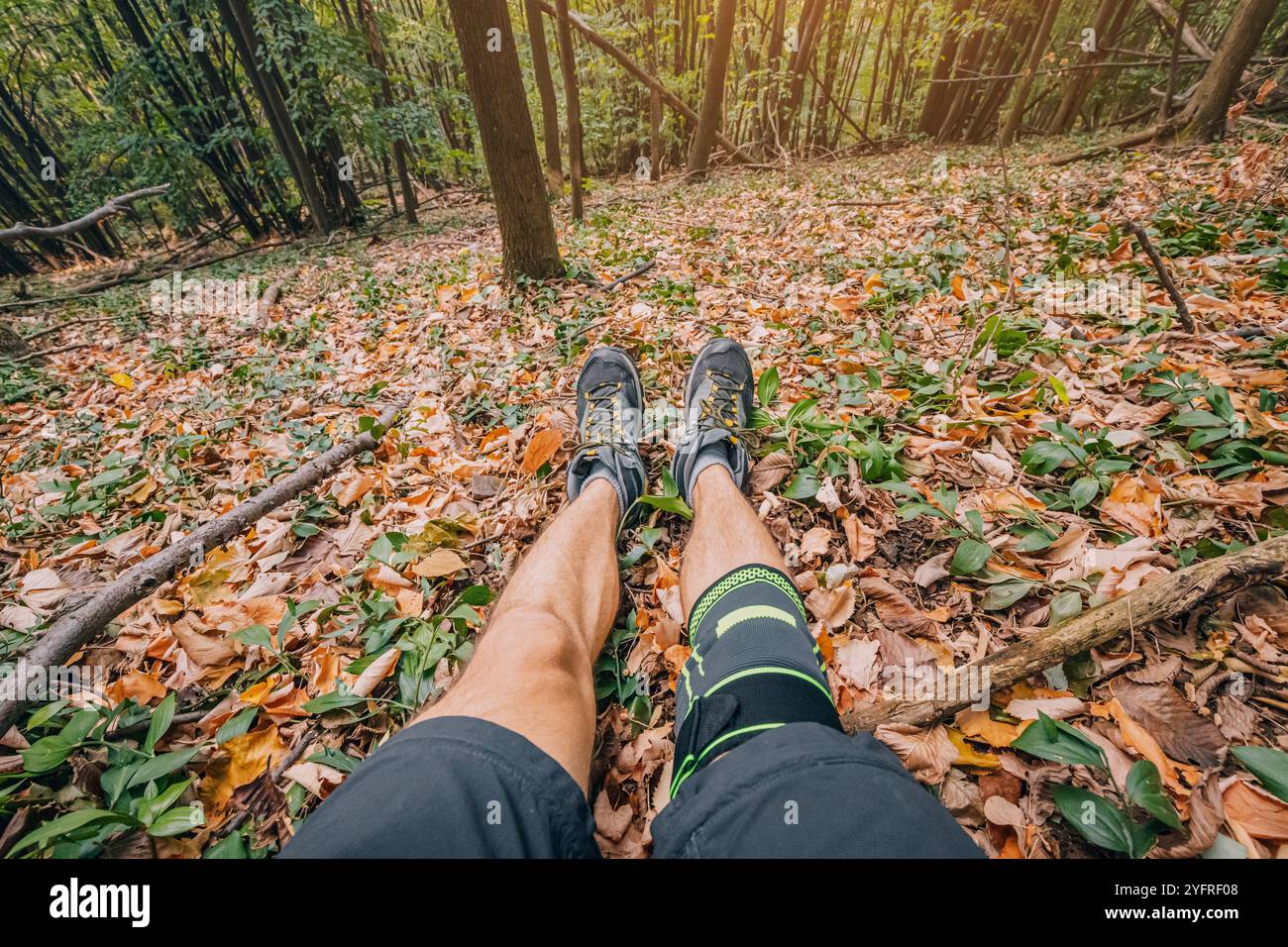 A hiker's legs positioned on a forest trail, featuring a soft knee ...