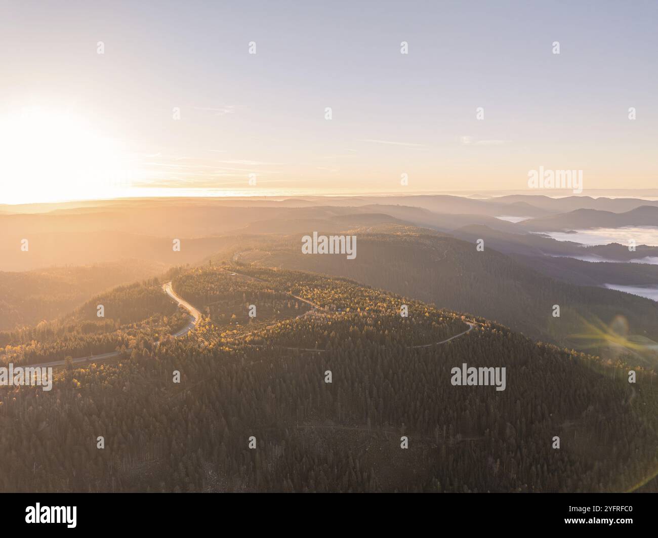 Morning landscape at sunrise over dense forests and hills in Panorama ...