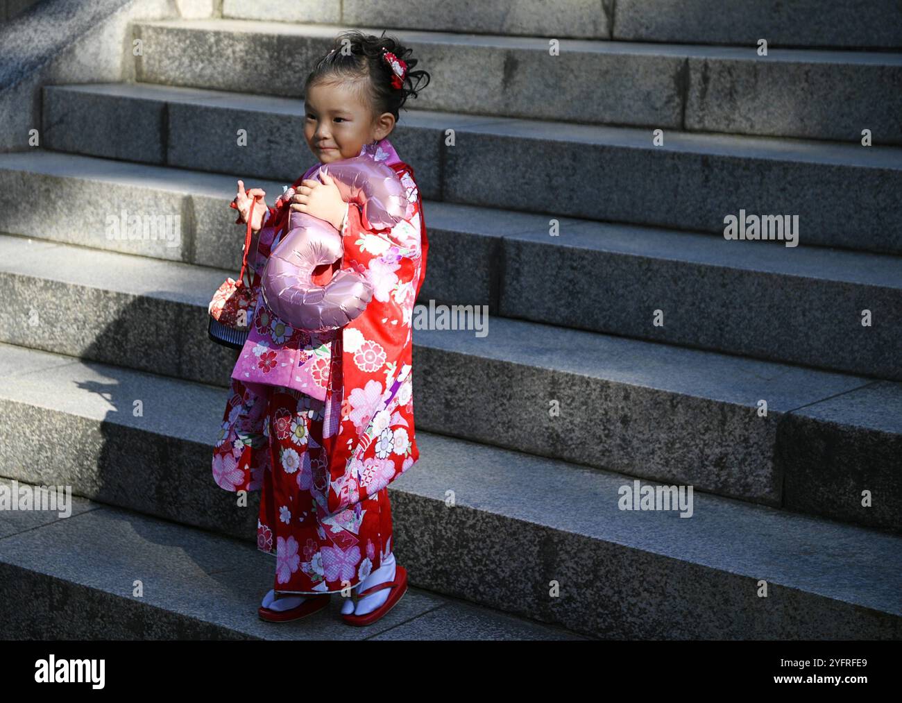 Portrait of a little girl wearing a traditional Japanese Kimono costume ...