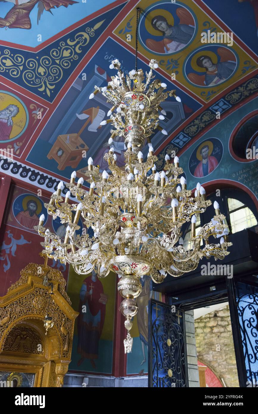 Magnificent chandelier in front of colourful, religious wall paintings ...