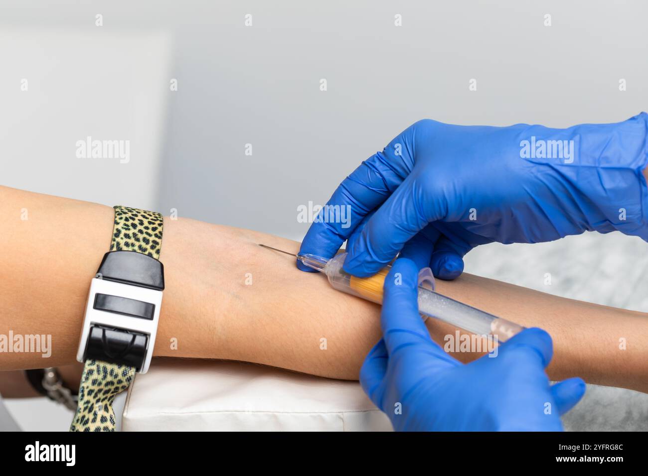 Close-up shot of healthcare worker wearing gloves ready to take a blood ...