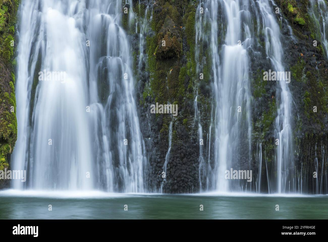 Waterfall from the source of the Lison in a haven of peace with its ...