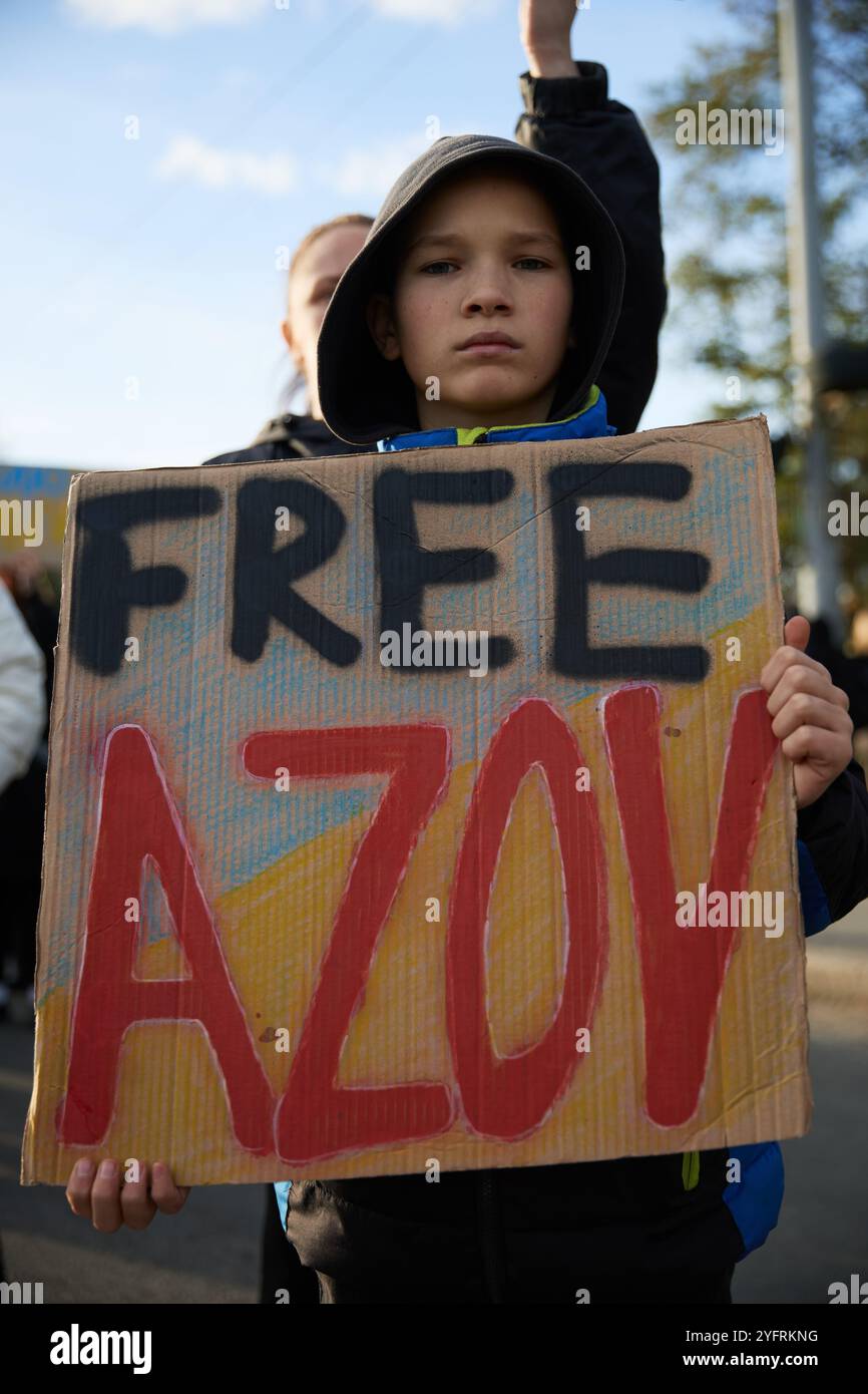 Sad young Ukrainian boy demonstrating with a poster Free Azov in Kyiv - 3 November,2024 Stock ...