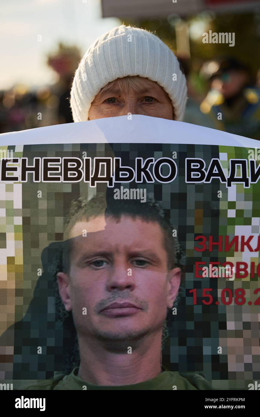 Senior Ukrainian woman, mother posing with a poster of her missing son ...