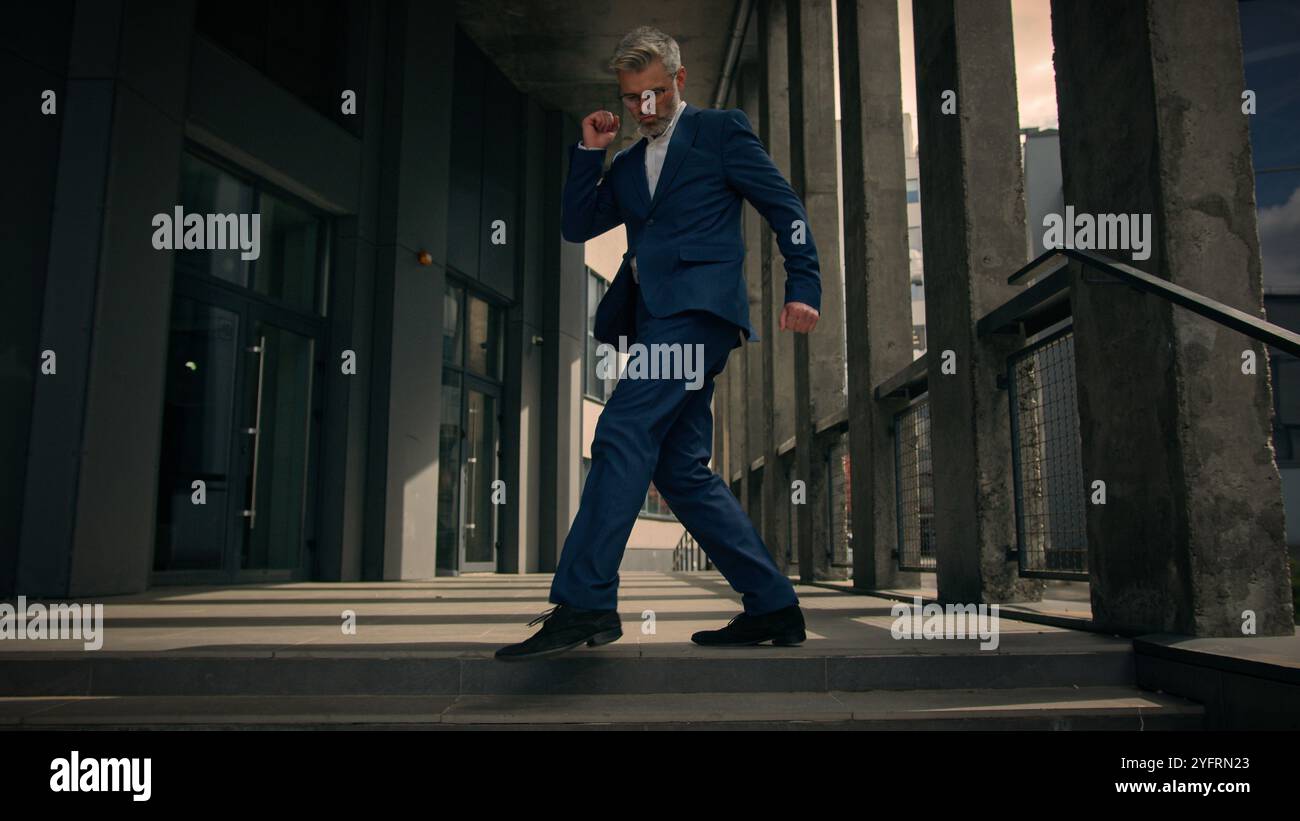 Funny moving happy Caucasian senior business worker employee mature man ...