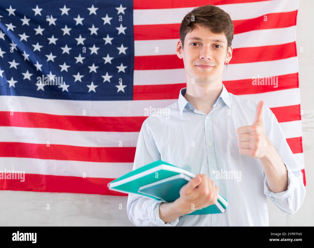 Positive student on background of flag of USA - concept of studying ...