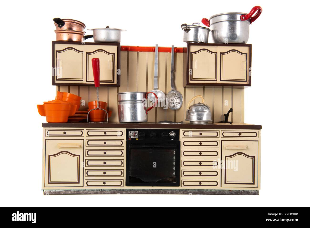 Miniature vintage toy kitchen with utensil isolated over white ...