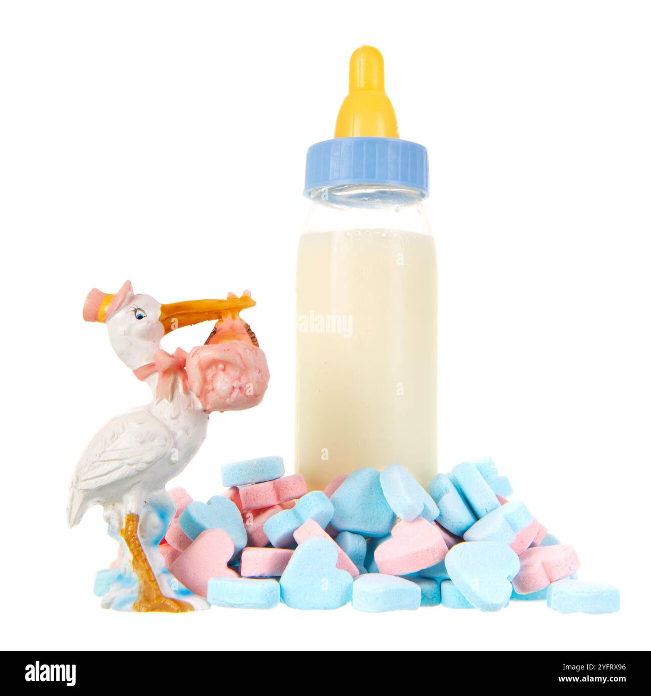 Baby bottle milk with stork and candy hearts isolated over white ...